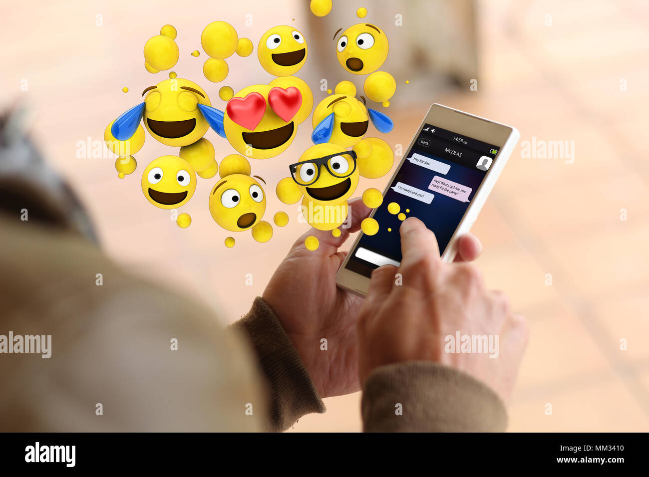 man touching the screen of his smartphone to send emoticons. All screen ...
