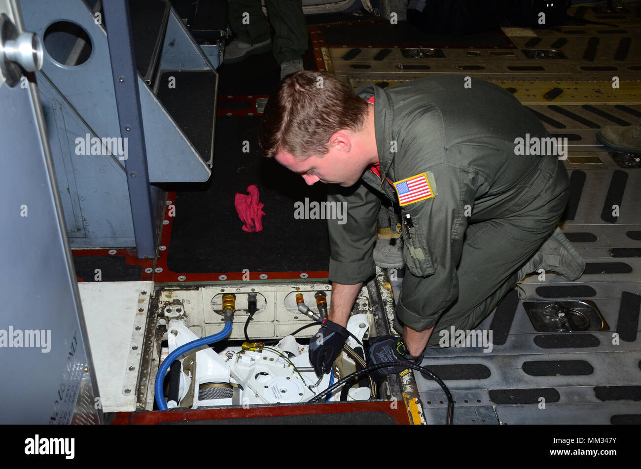 183AS Loadmaster, SSgt. Mitchell Baker inspects the winch on 172d ...