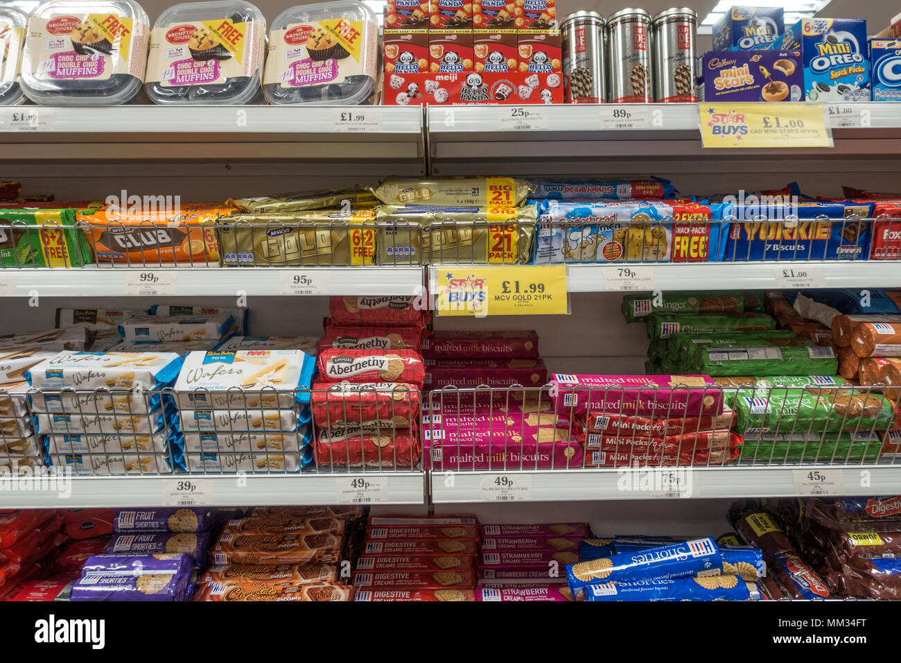 A shelf of tasty treats of cakes and biscuits Stock Photo - Alamy
