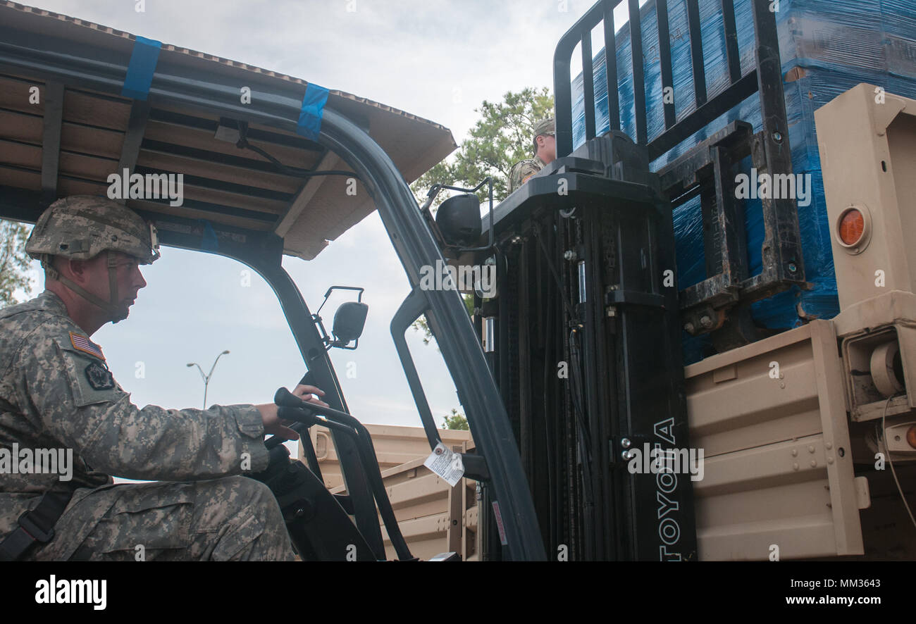 Soldiers assigned to the 36th Engineer Brigade, load their vehicles ...