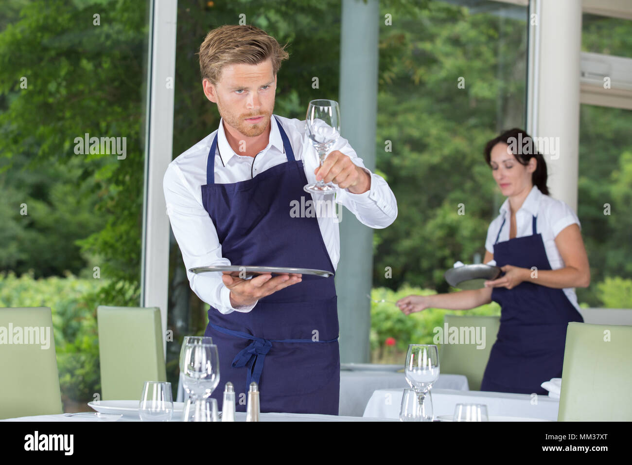 Waiter checking glassware Stock Photo - Alamy
