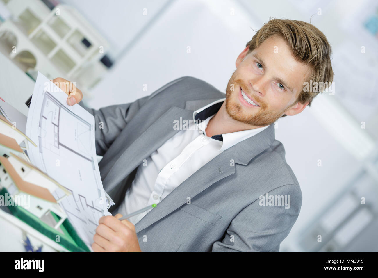 happy smiling engineer working on plane of house Stock Photo - Alamy
