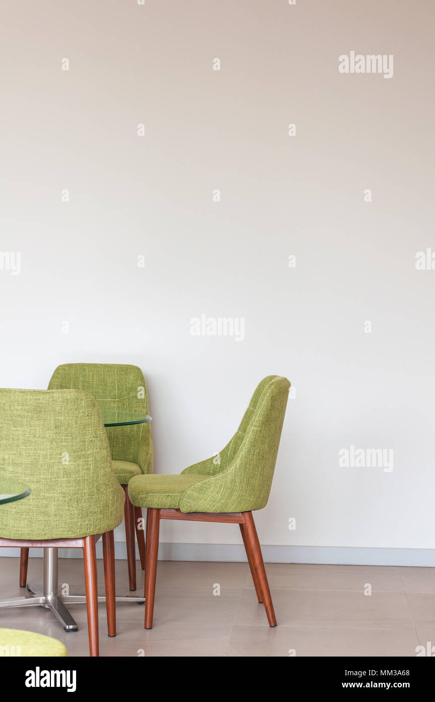 Close up green chair modern style on white concrete corner background ...