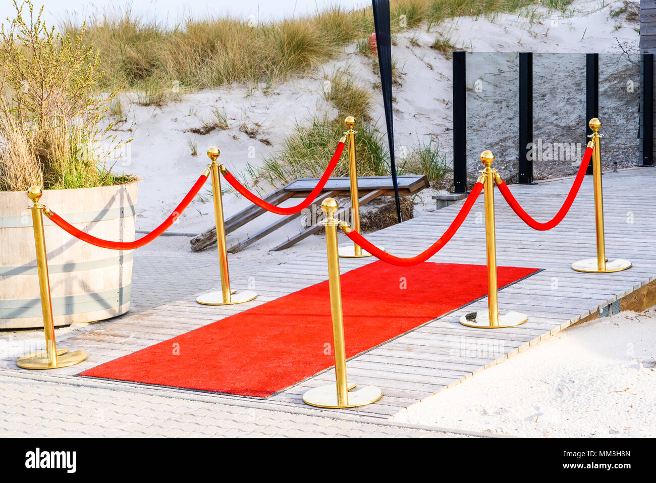 Skanor, Sweden - Red carpet on a wooden outdoor ramp with sand dunes in ...
