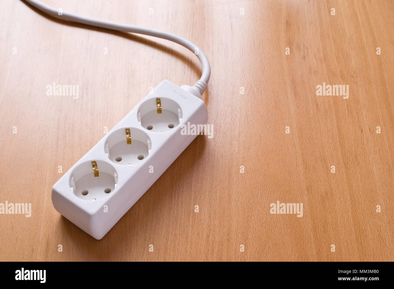Multiple socket outlet on wooden floor Stock Photo - Alamy