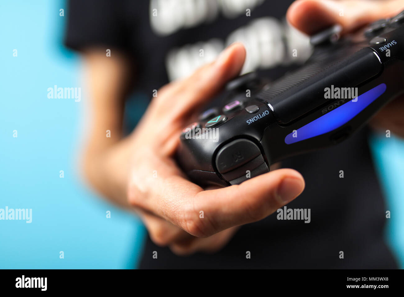Male hands holding a PS4 controller Stock Photo - Alamy
