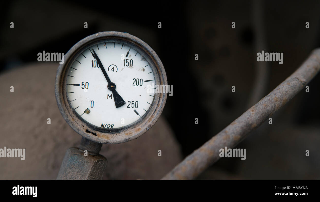 Industrial old white vintage barometer with old dirty gas cylinder ...