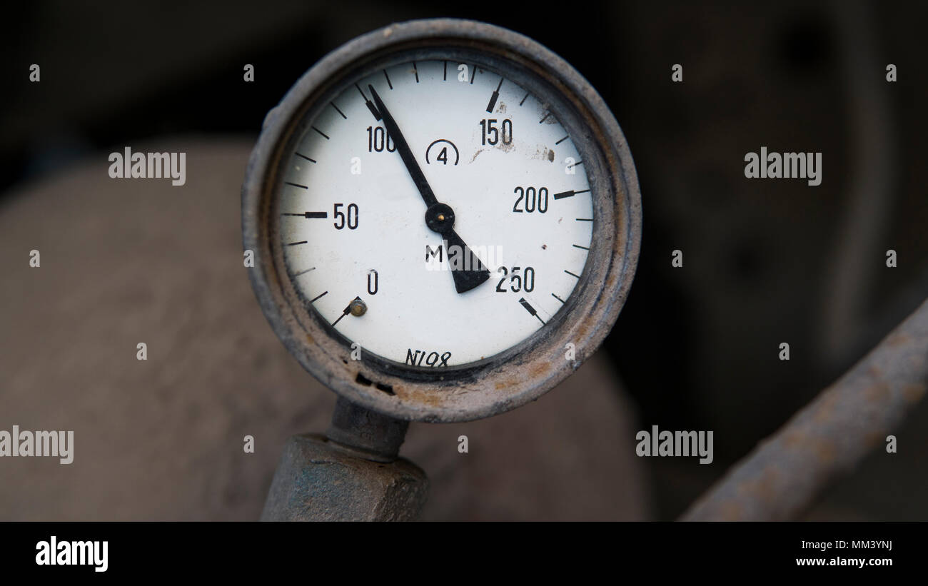 Industrial old white vintage barometer with old dirty gas cylinder ...