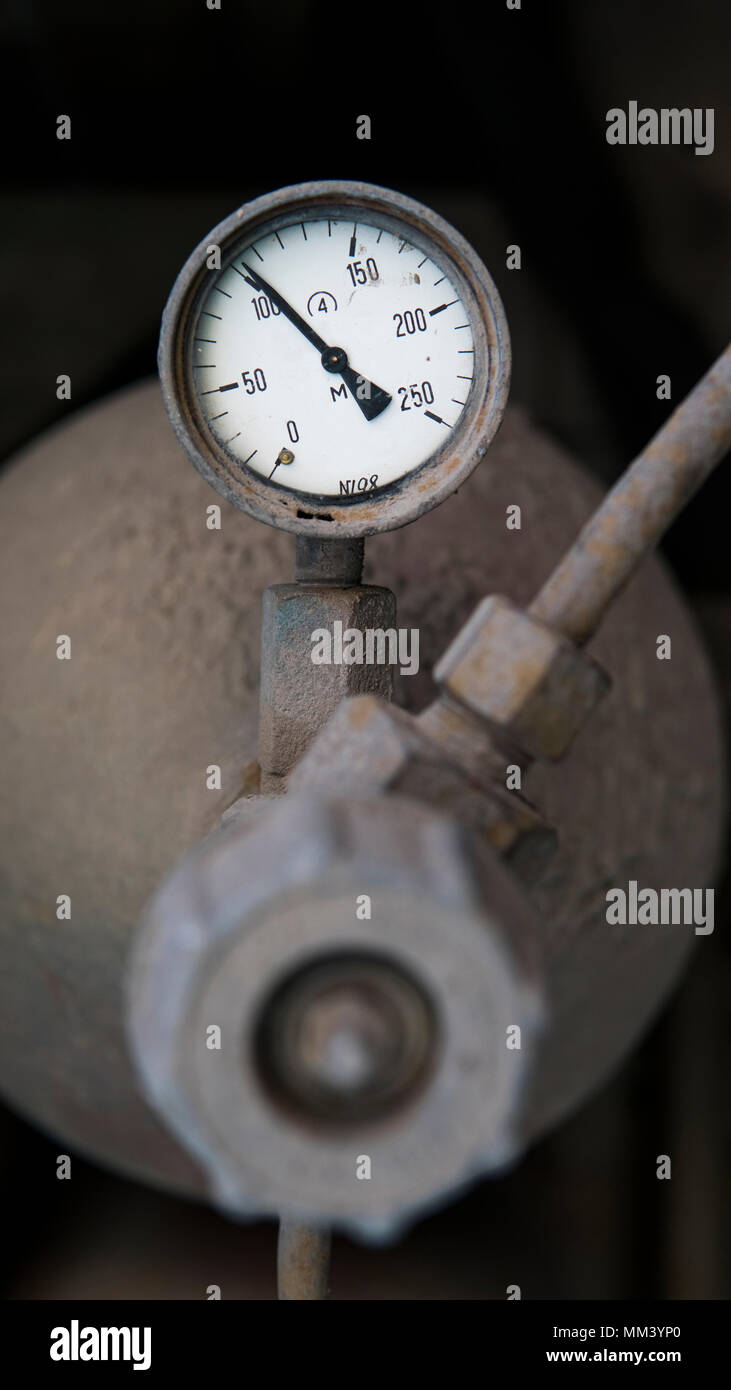 Industrial old white vintage barometer with old dirty gas cylinder ...