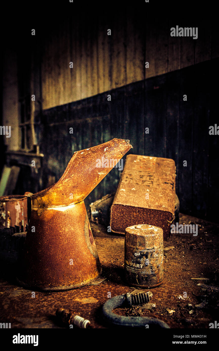 collection of rusty old cans on a workbench in a ruined garage Stock ...