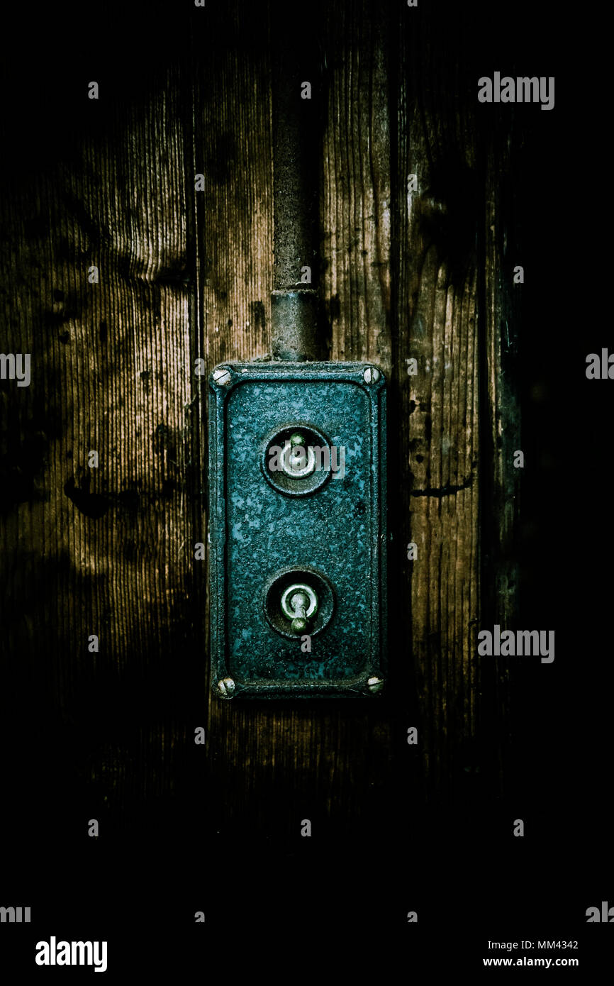 vintage grey metallic electrical double wall switch on wooden panelled ...