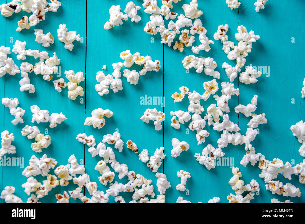 Popcorn texture. Popcorn snacks as background. on blue wood background ...