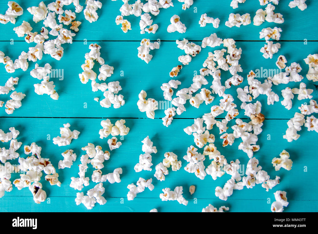 Popcorn texture. Popcorn snacks as background. on blue wood background ...