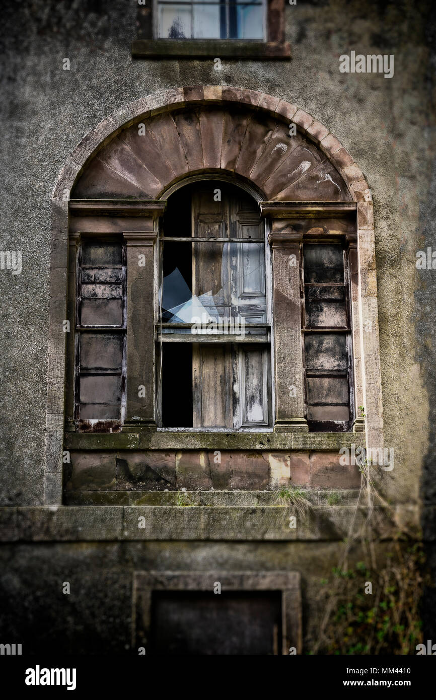 boarded wrecked arched window Stock Photo - Alamy
