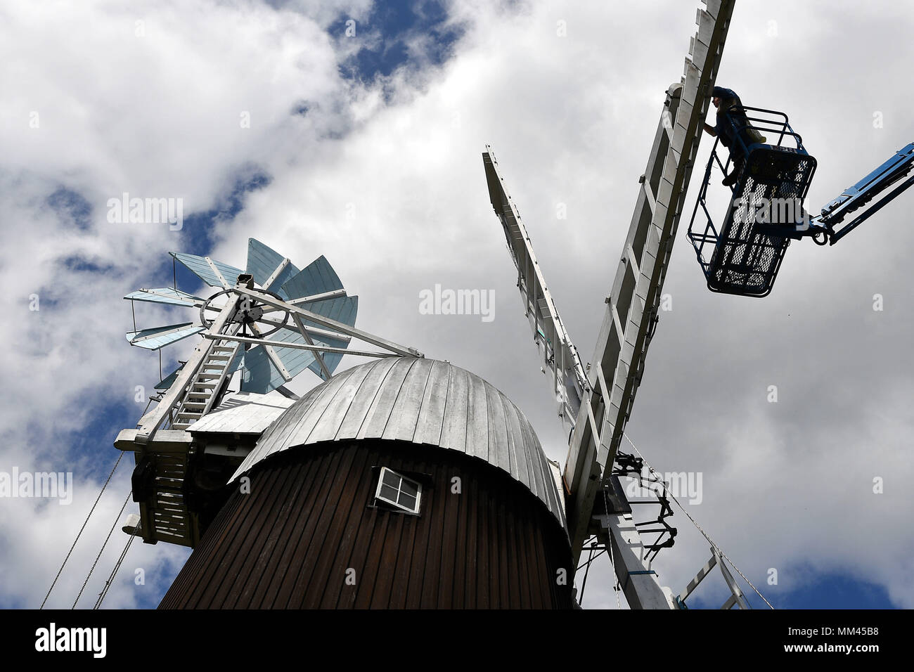 A new sail is fitted to Wicken Village windmill in Cambridgeshire Stock ...