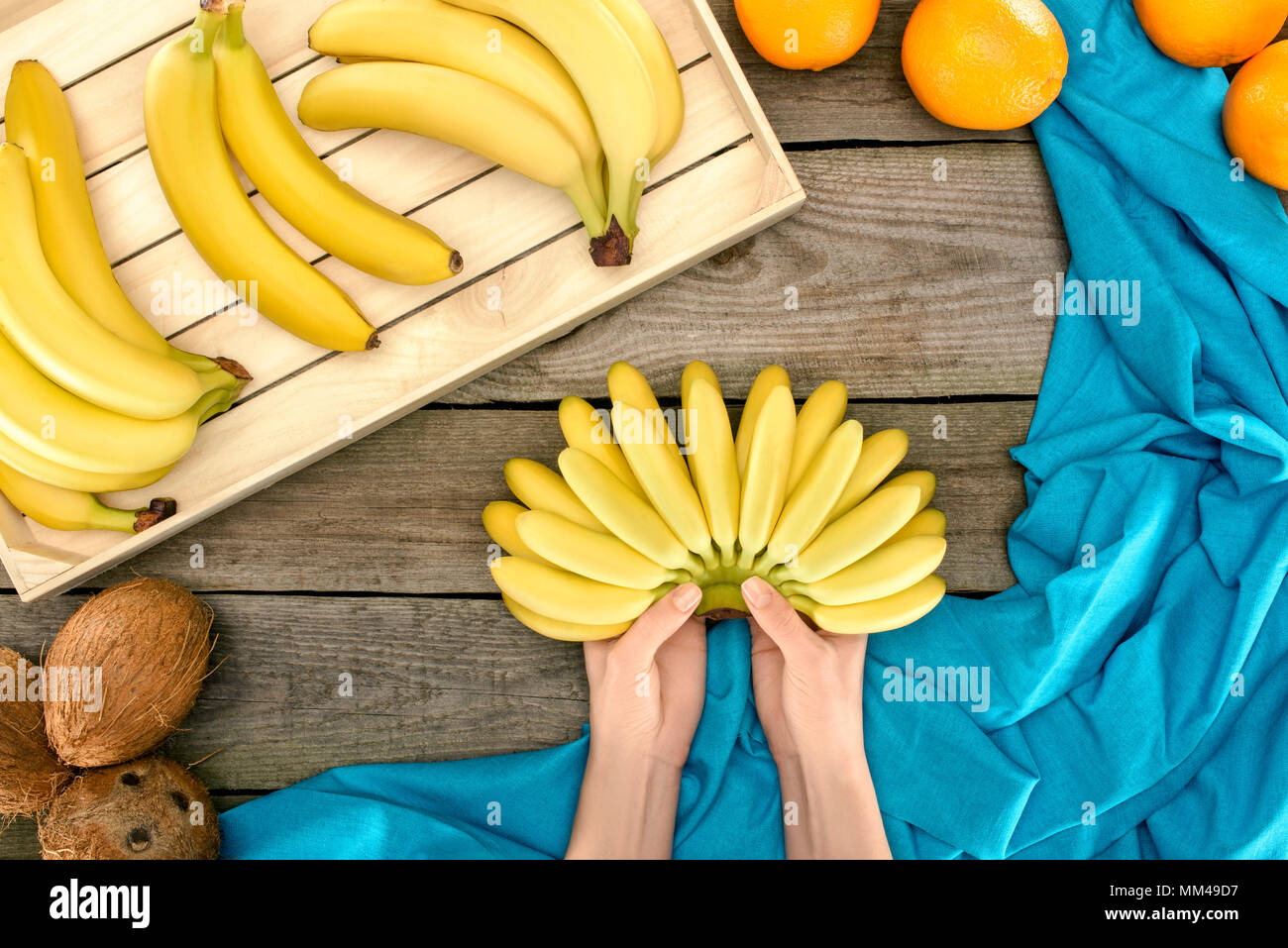 bunch of bananas in hands Stock Photo - Alamy
