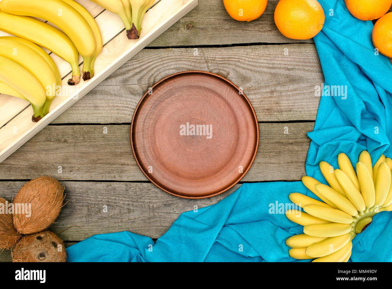 tropical fruits and empty plate Stock Photo - Alamy