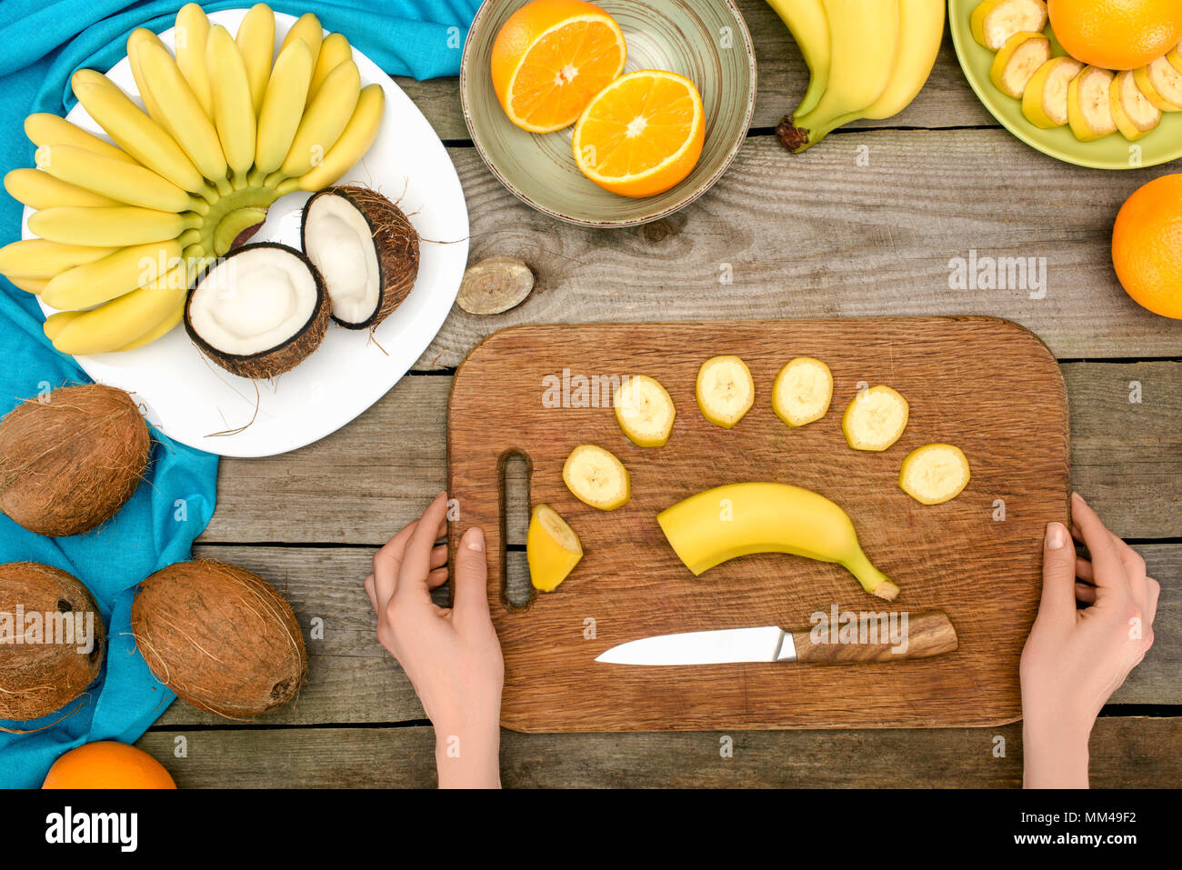 person slicing banana Stock Photo - Alamy