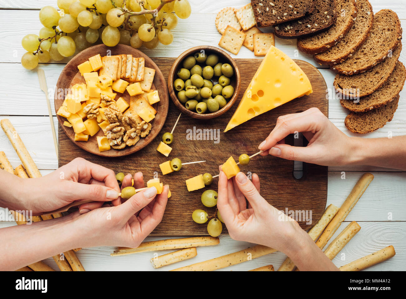 women making canapes with cheese Stock Photo - Alamy