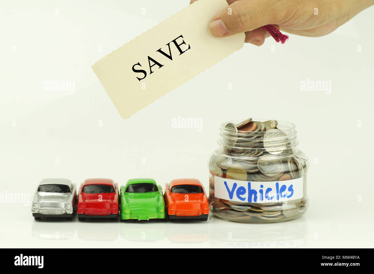 hand holding sign of save on jar of money and car, concept in save ...