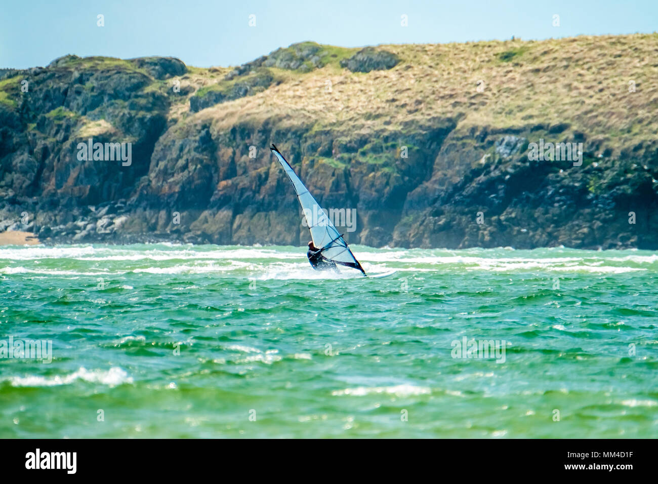 Wind surfer enjoys the beach at Newborough Warren with the Island of ...
