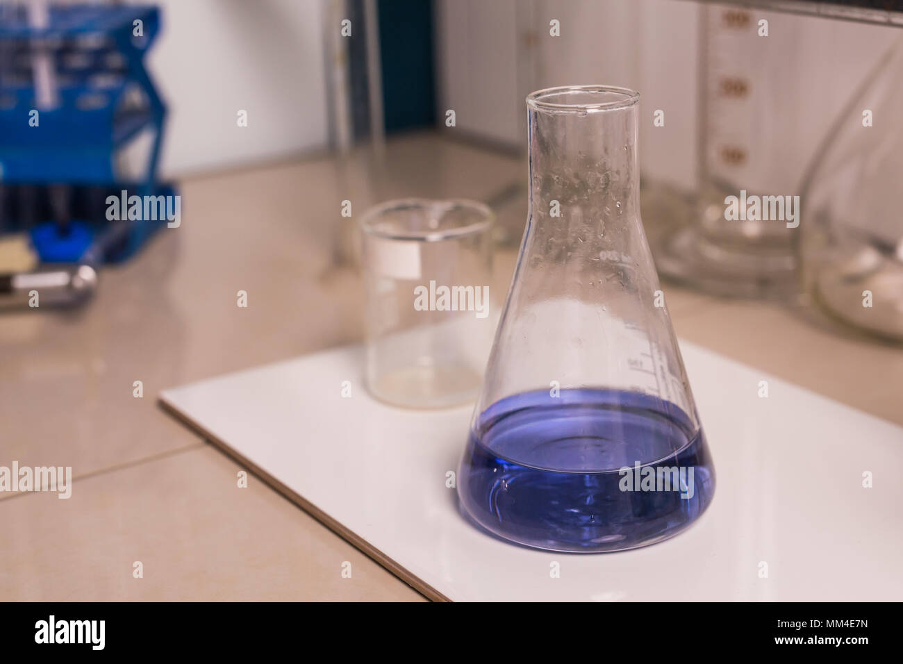 Laboratory flask with blue liquid Stock Photo - Alamy