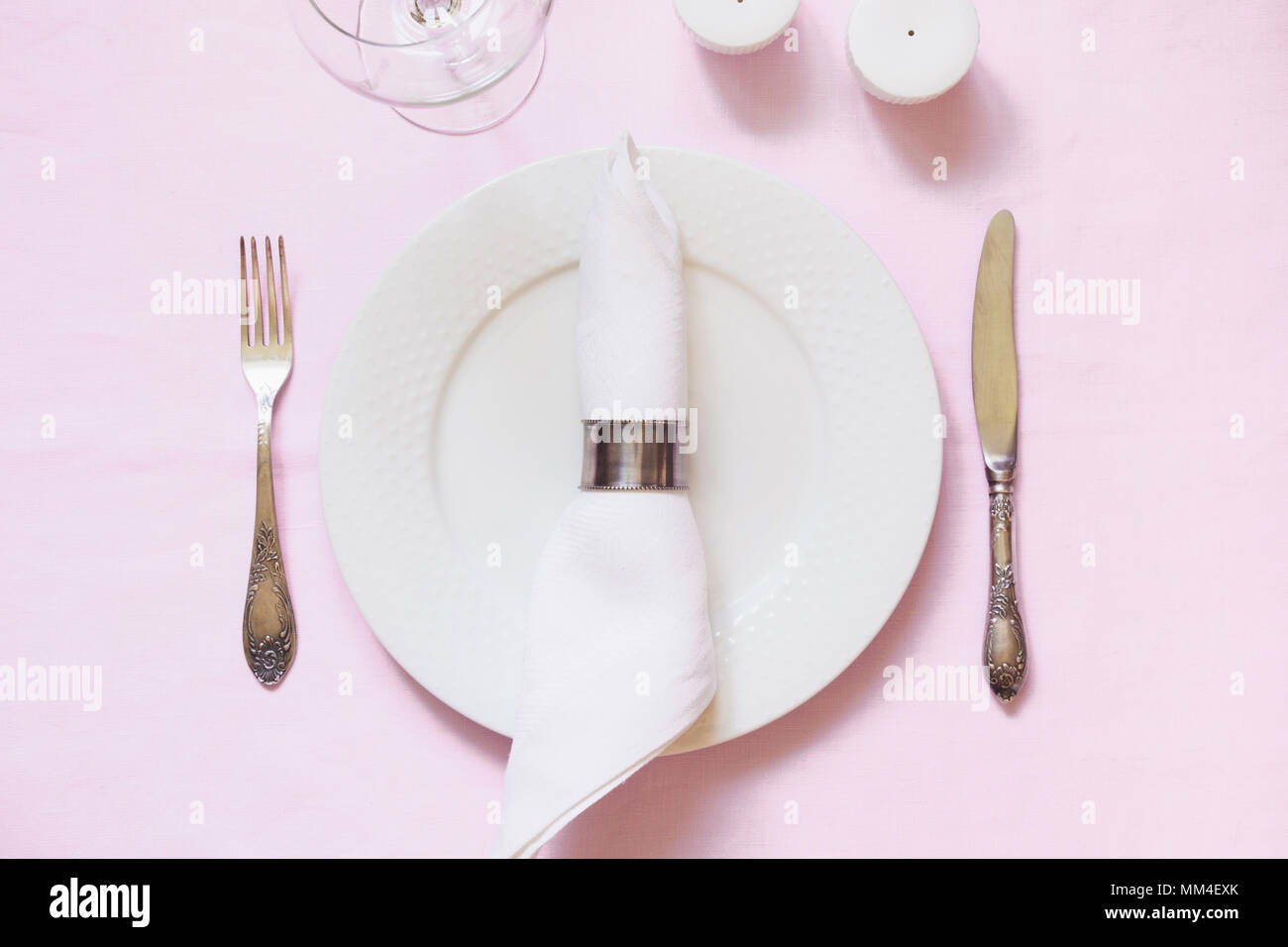 Table place setting on pink linen tablecloth. Top view. Concept Stock ...