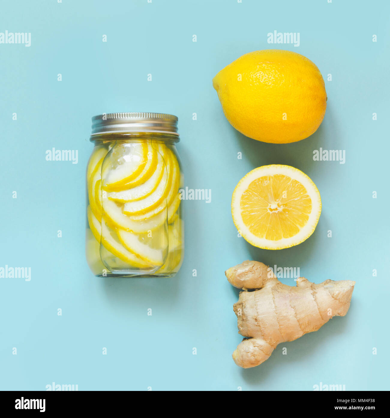 Healthy detox water with ginger and citrucs in mason jar on punch blue ...