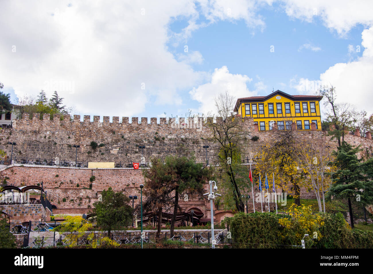 looking from street at famous old wall of castle and yellow house in ...