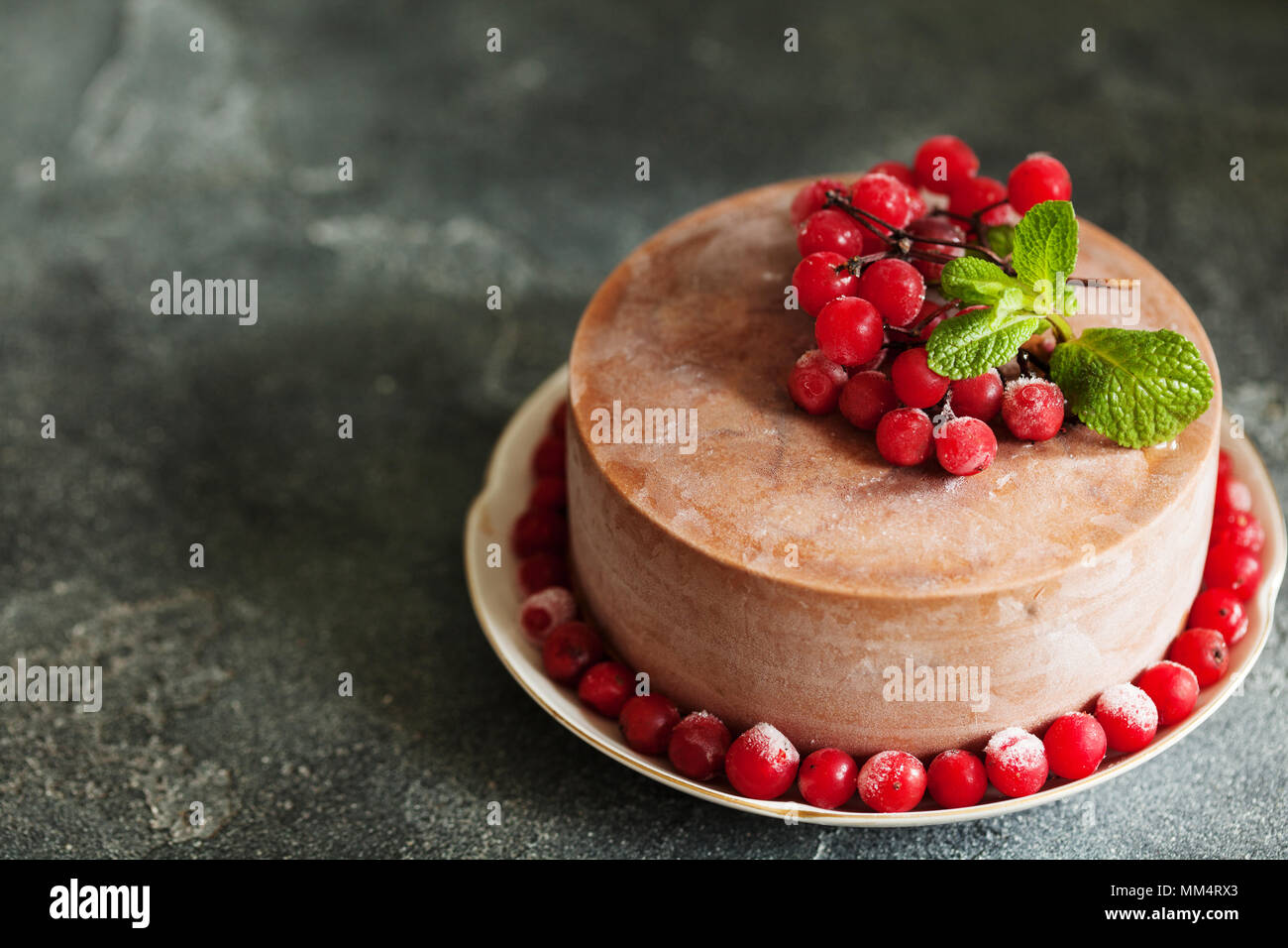Chocolate mousse cake with lingonberry fruits and mint copy space Stock ...