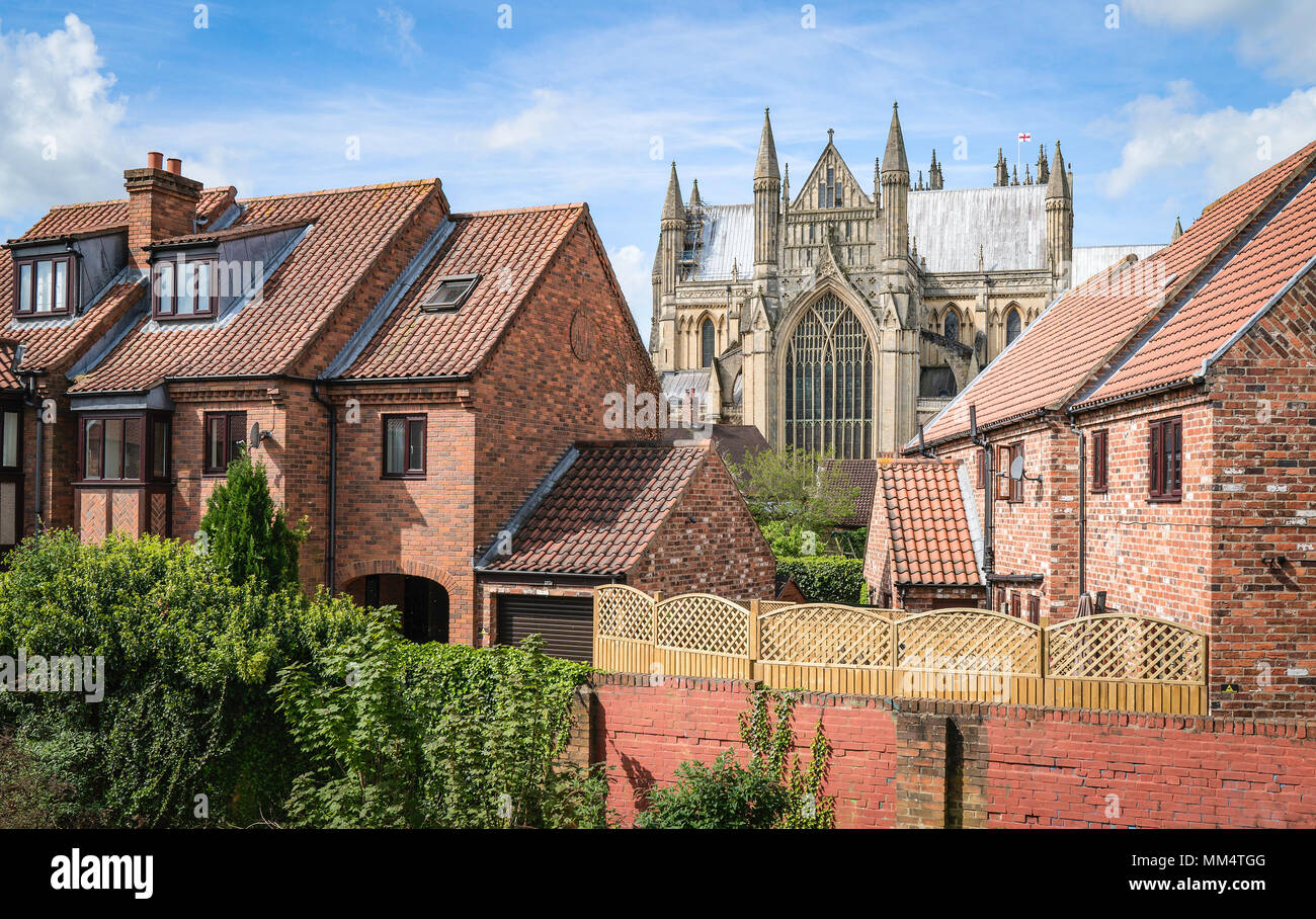 The ancient minster flanked by modern townhouses on a bright spring ...