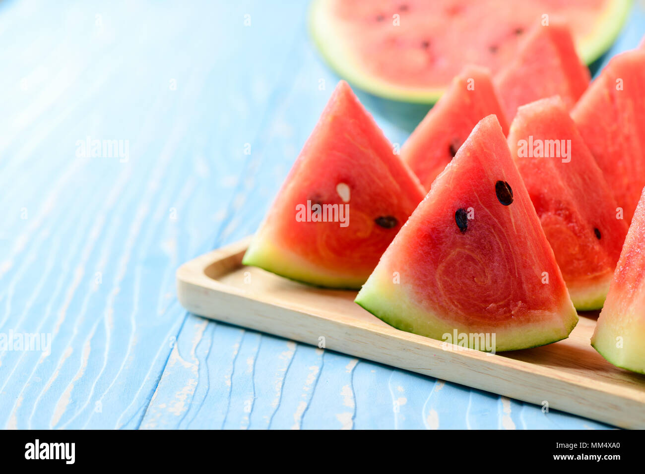 Slice of watermelon on blue wood background, fruit in summer concept ...
