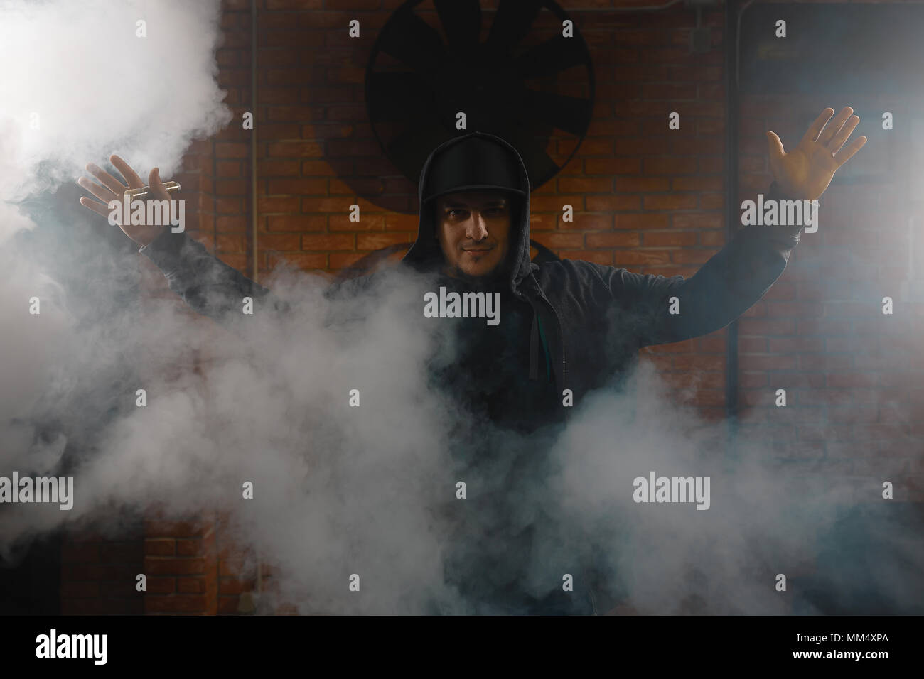 A Cloud Of Vapor Vaping Man Holding A Mod Brick Background Vape