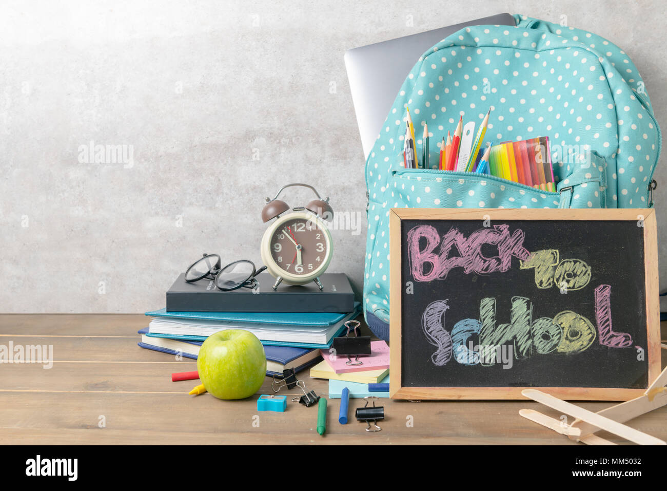 School backpack with coloured pencil and back to school text on ...