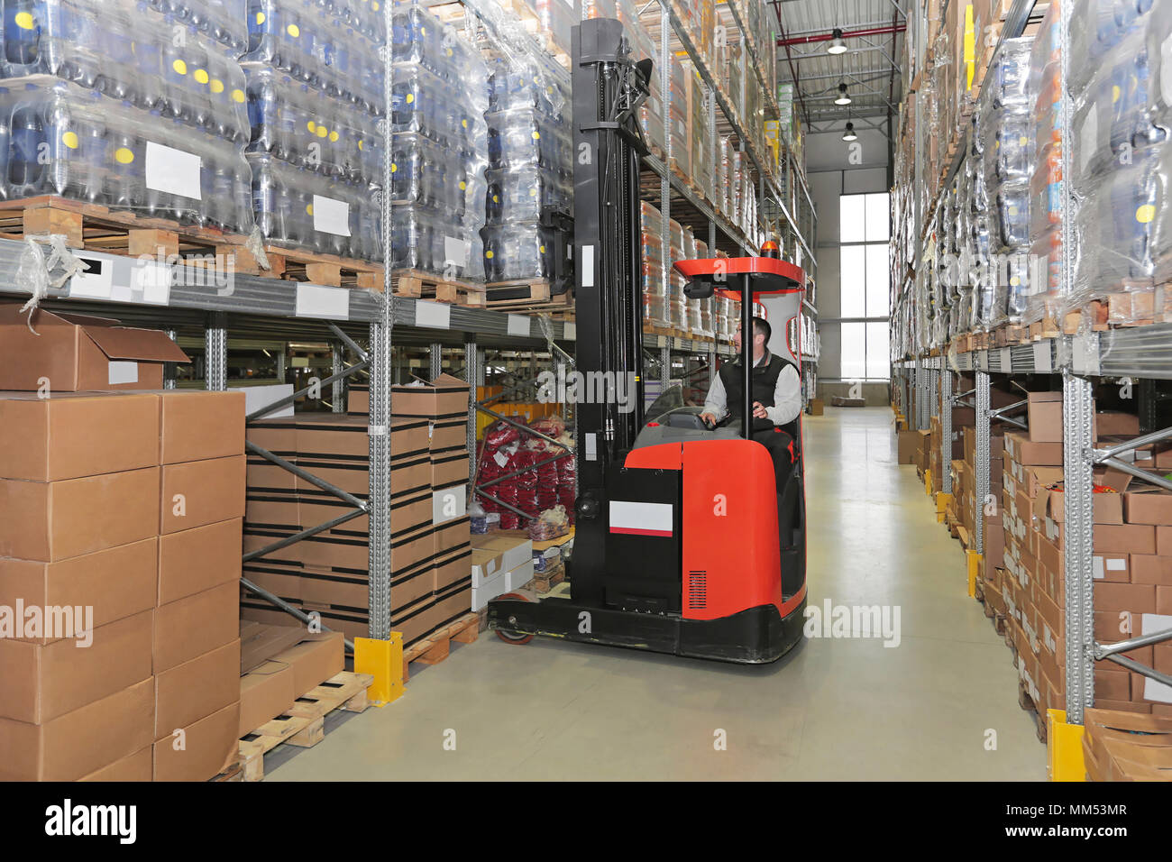 Forklift Loading Pallet With Goods in Distribution Warehouse Stock ...
