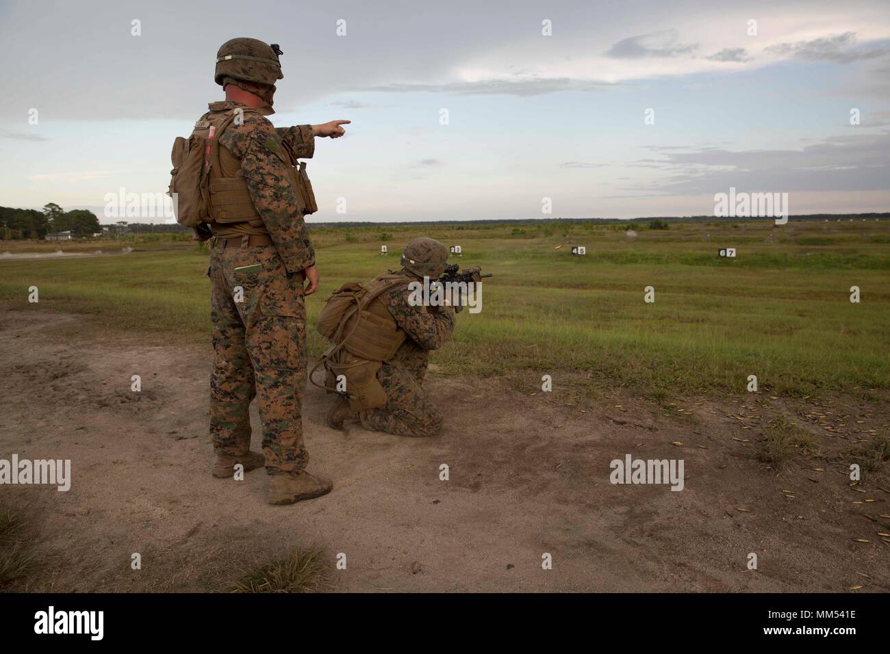 A range safety officer directs a Marine on the firing line during a ...