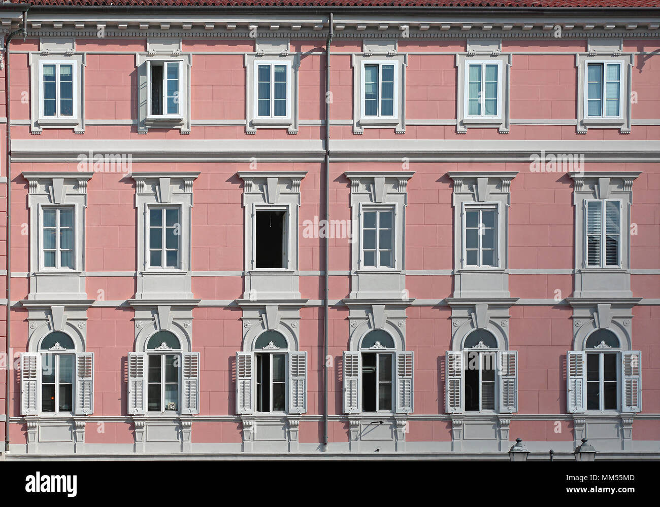 Pink Building With Classic Style Windows in Trieste Stock Photo - Alamy