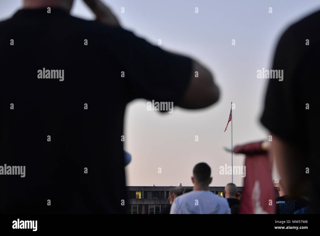 Fort George G. Meade service members salute during revile as the U.S ...