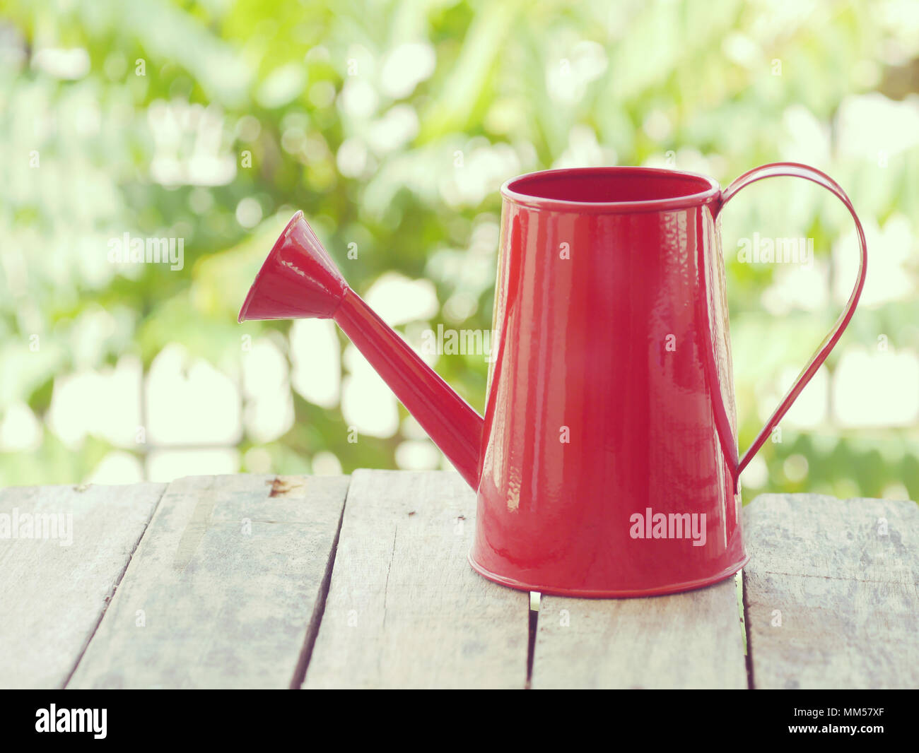 Red watering can retro vintage style Stock Photo - Alamy