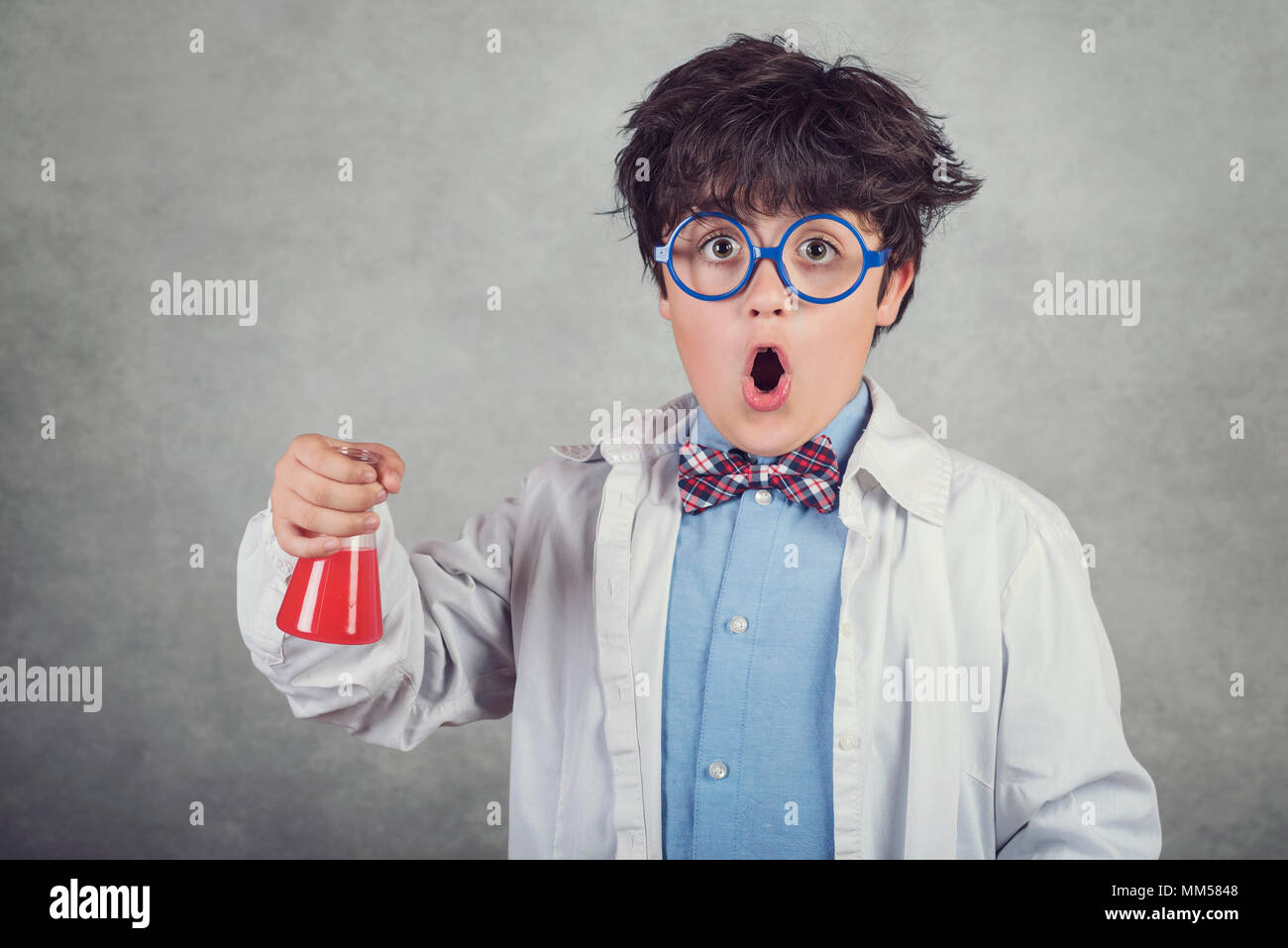 boy is making science experiments on gray background Stock Photo - Alamy