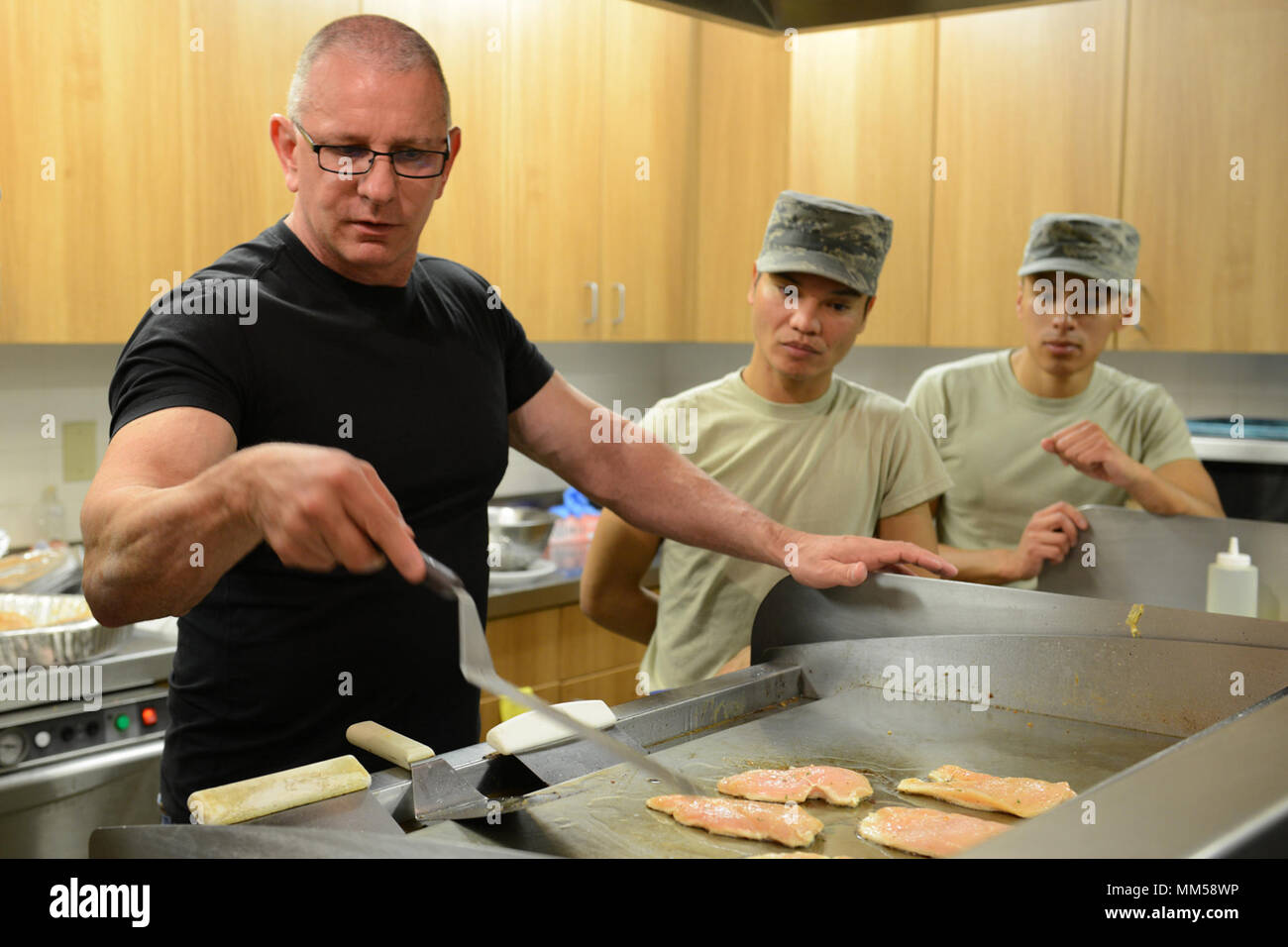 Celebrity Chef Robert Irvine shows Airman First Class Nicki Agunos ...