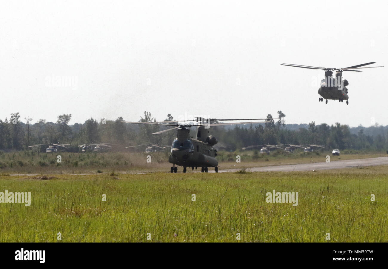 A flight of CH-47F Chinooks descend on Camp Shelby Joint Force Training ...