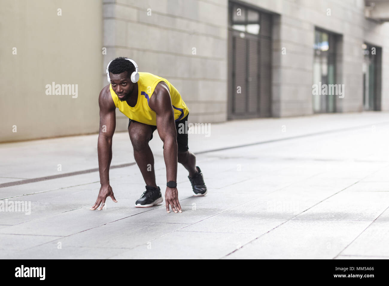 Black man running on city hi-res stock photography and images - Alamy