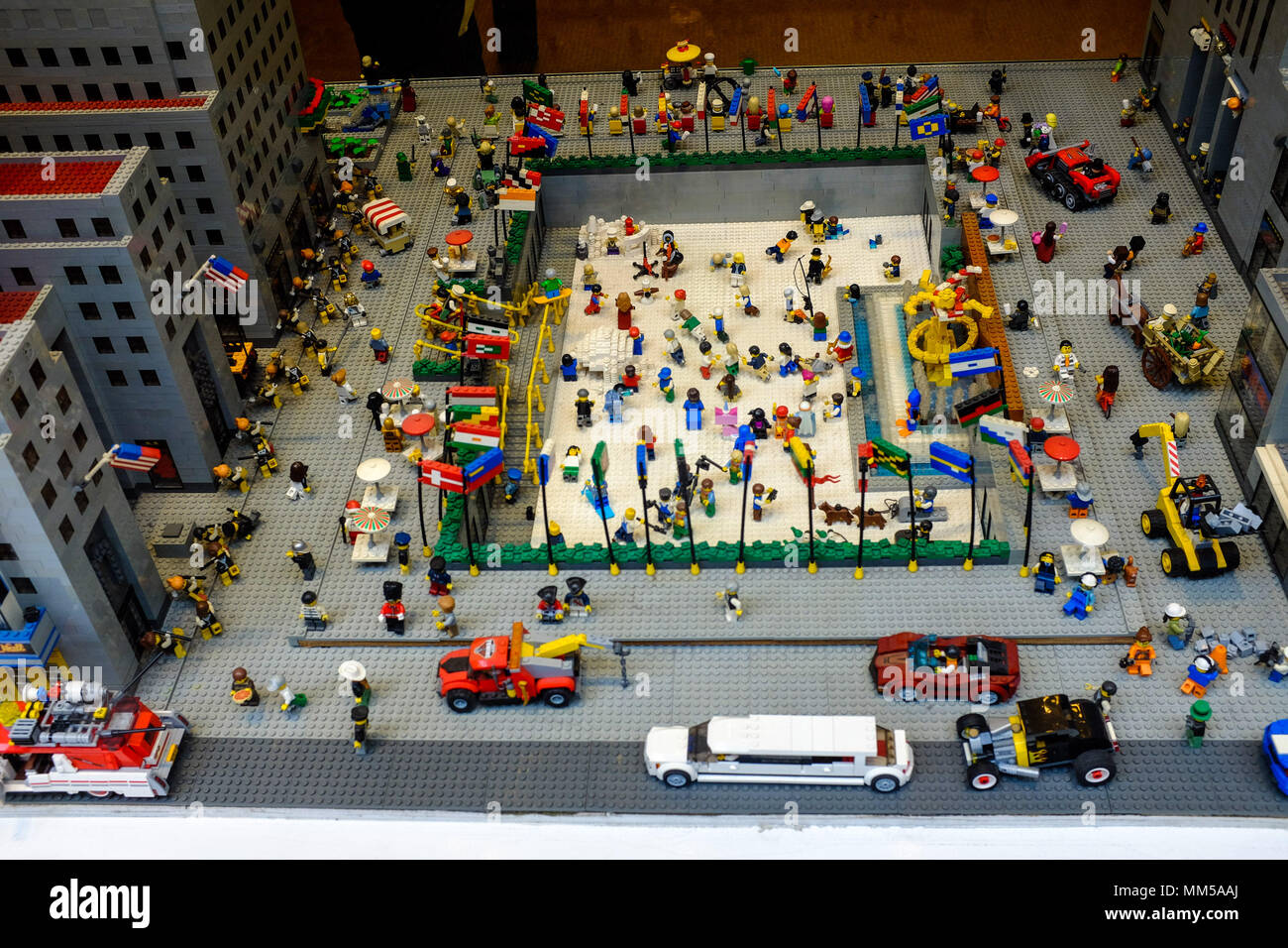 A young asian girl looks through the window of the Lego store at a ...