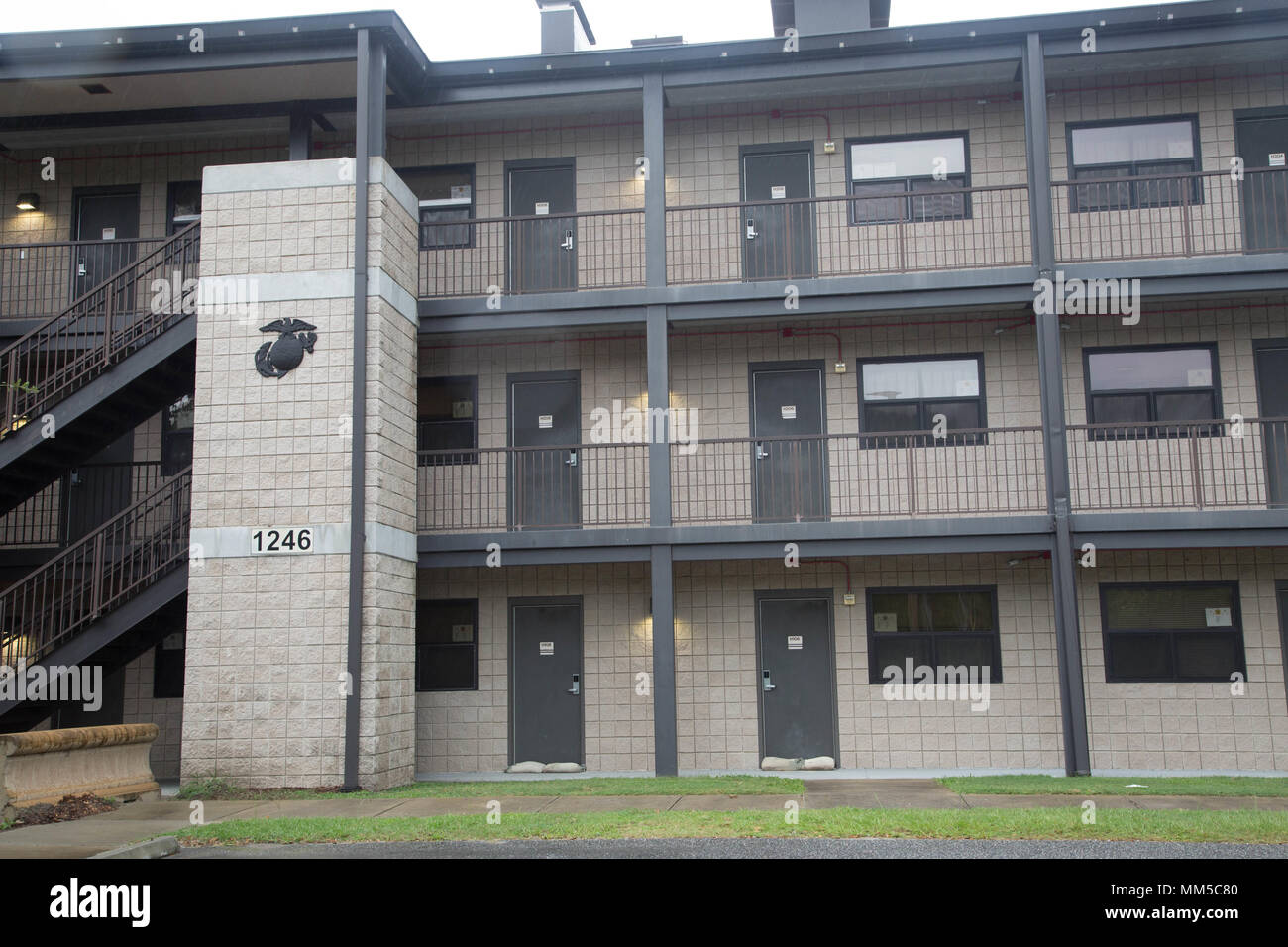 Sandbags are placed in front of first deck barracks room doors aboard ...