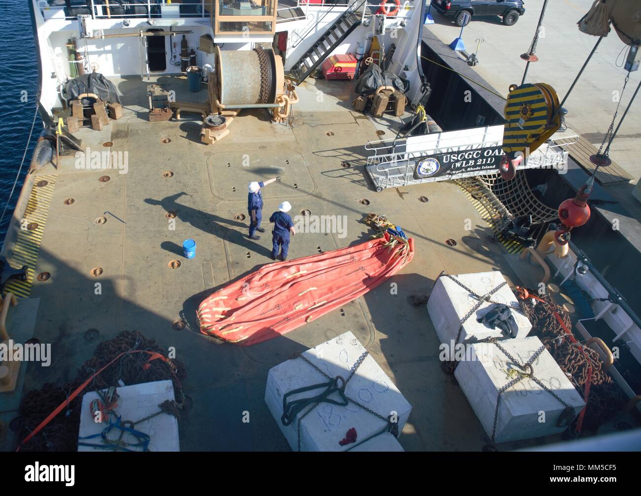 Coast Guard Cutter Oak crews stage sinkers and chain on the buoy deck ...
