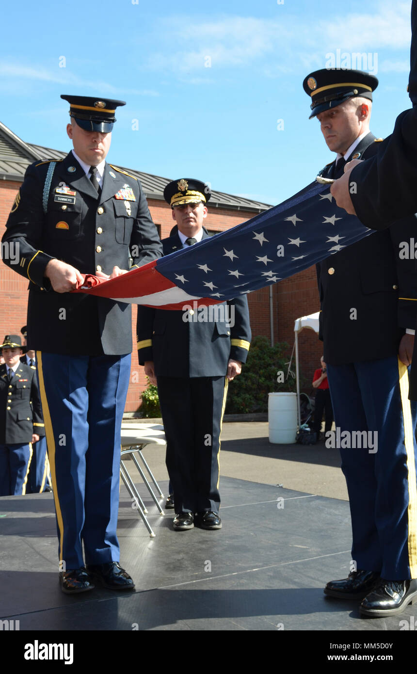 An Oregon Army National Guard color team folds an American flag during ...