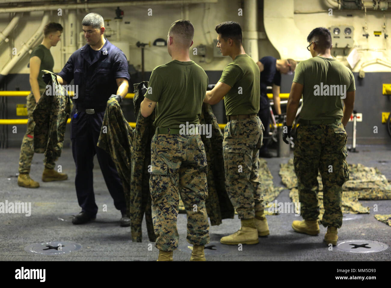 A U.S. Navy Sailor and U.S. Marines from the 26th Marine Expeditionary ...