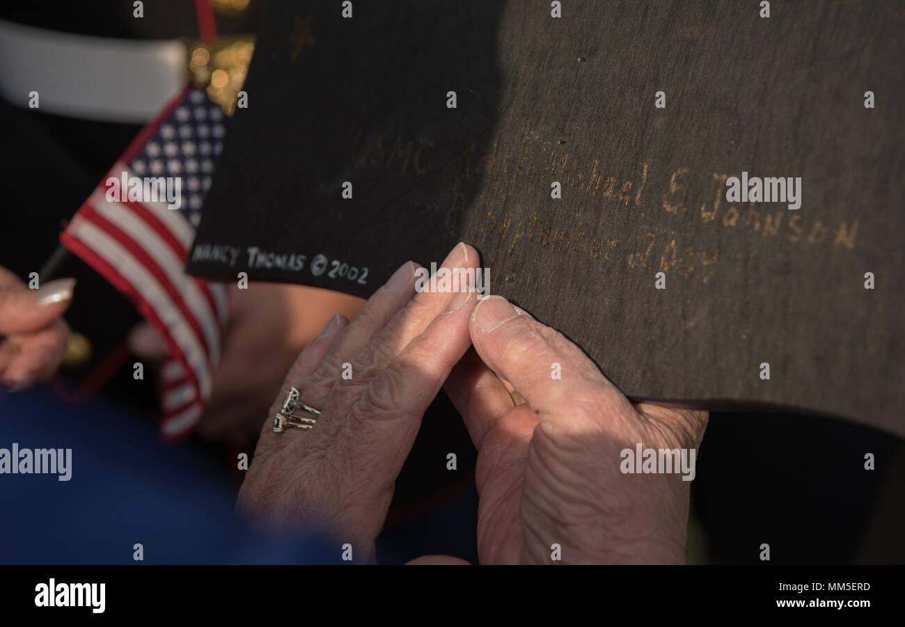 The Honorable Angela Lee Leary, right, reads the name of the son of ...