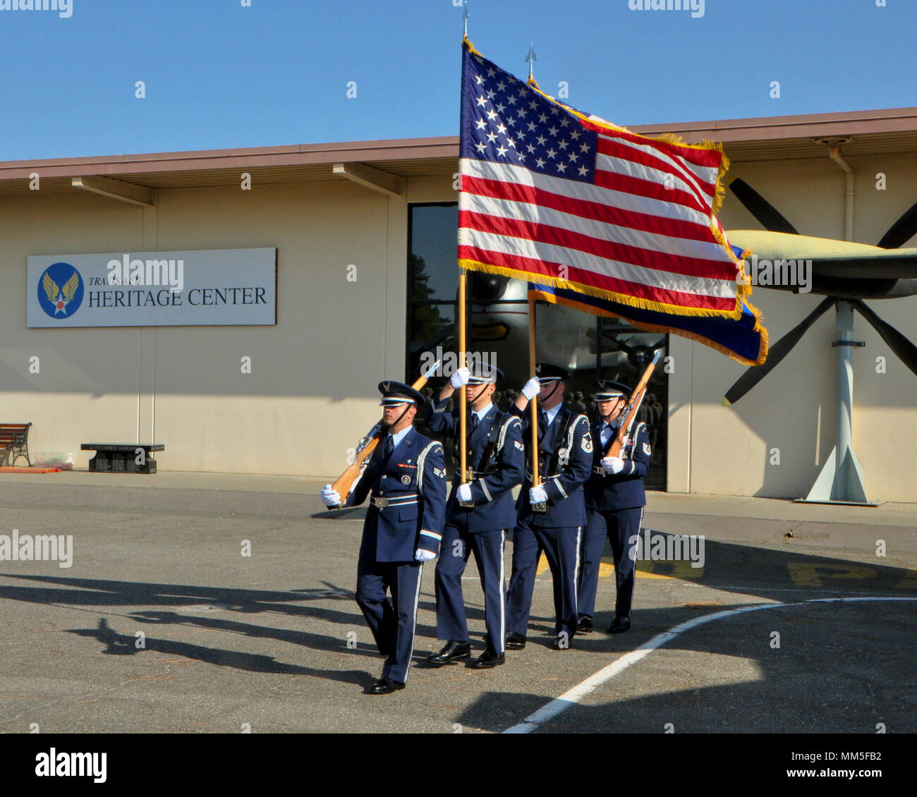 Members of the Base Honor Guard march in formation during a change of ...